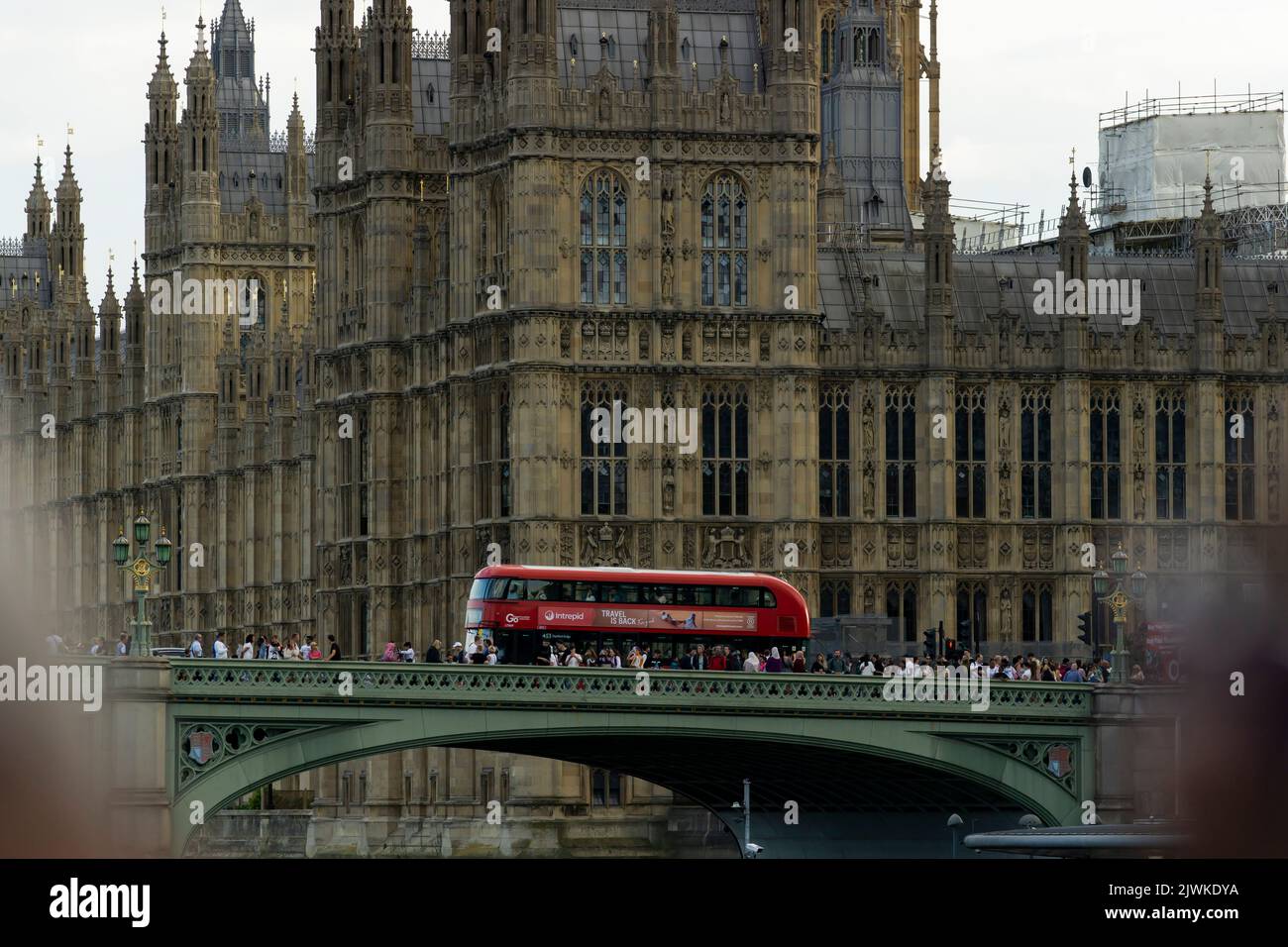Red London Bus crossing Westminster Bridge filled with Tourists Stock ...