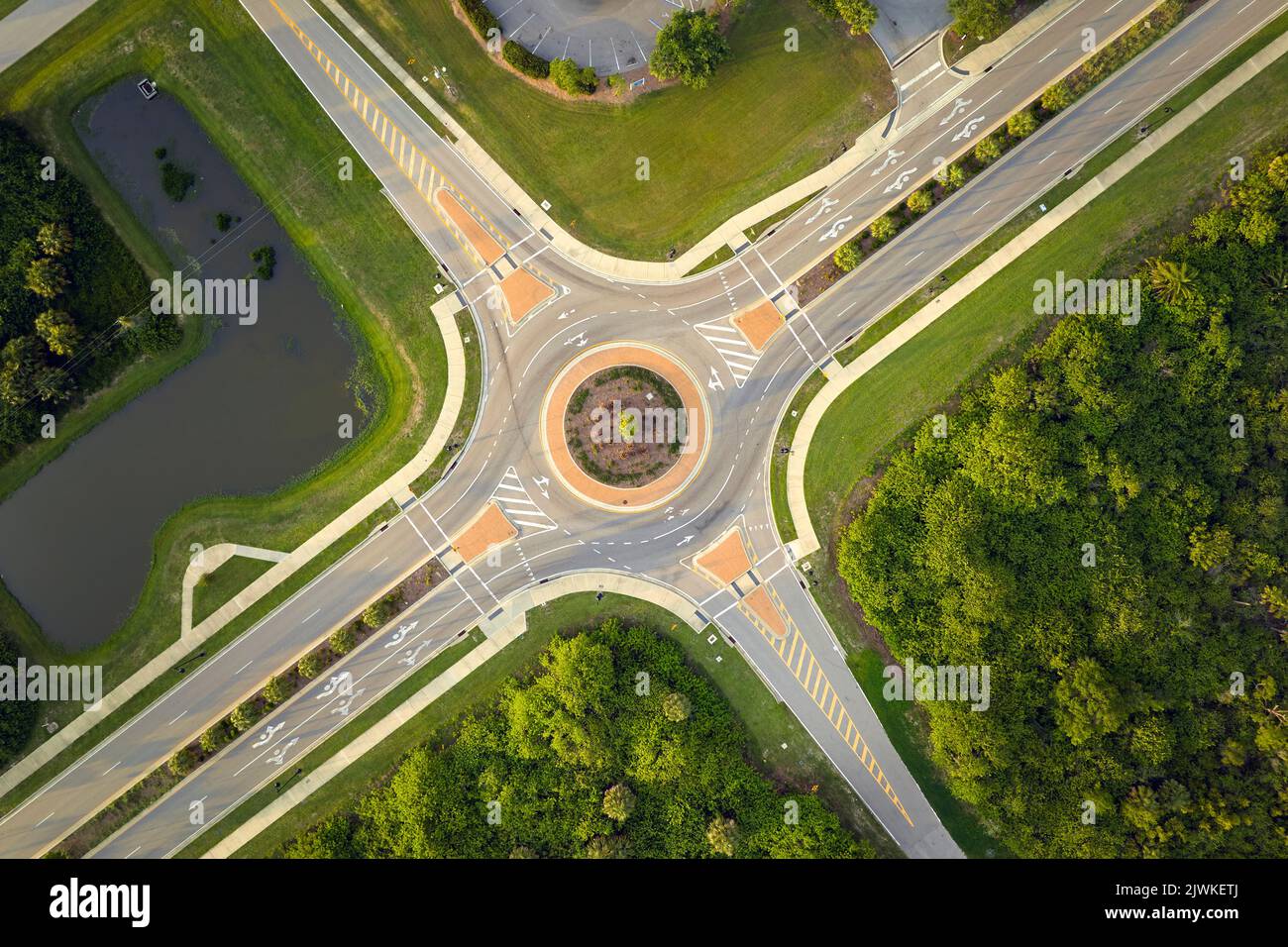 Aerial view of road roundabout intersection with moving cars traffic ...