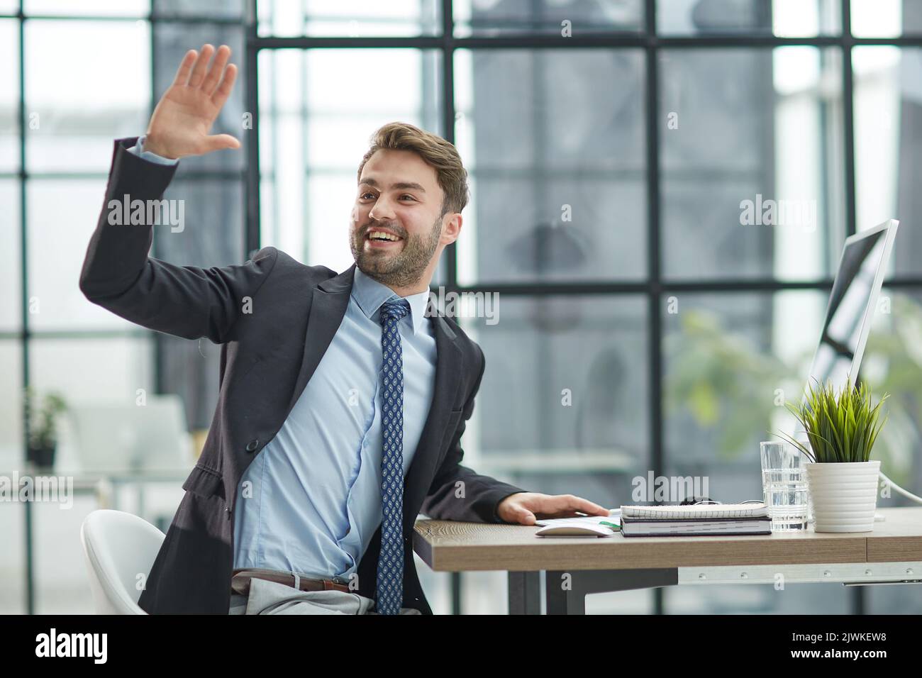 Hello by Man in Office, Indoor Waving Hand Stock Photo - Alamy
