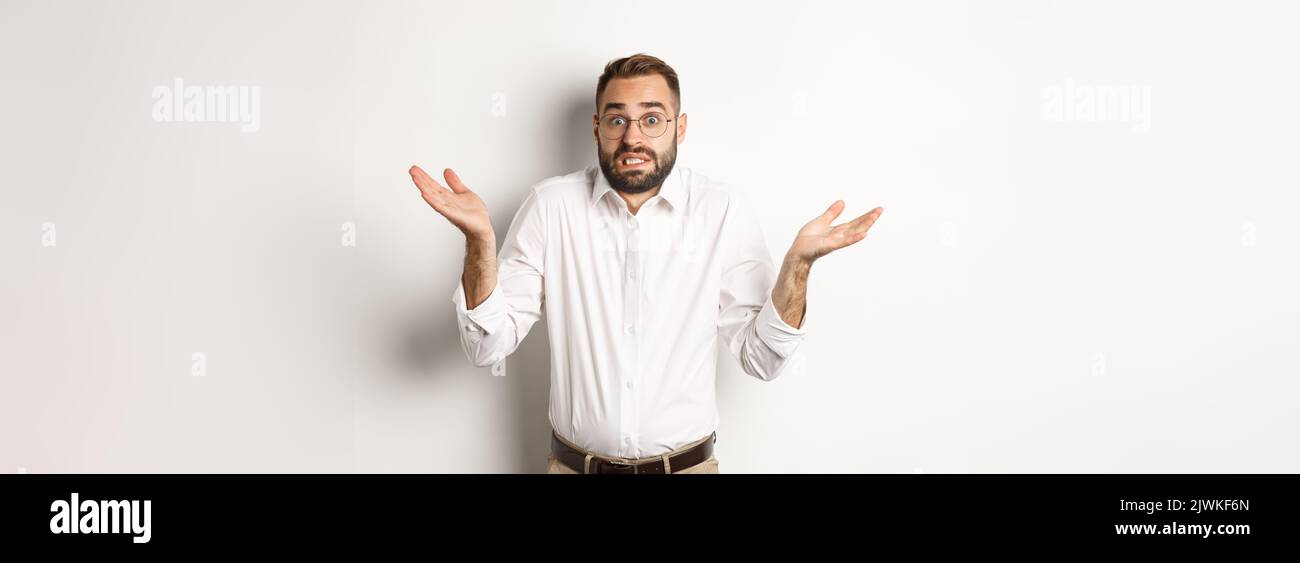 Clueless worried manager shrugging, looking confused, standing over ...