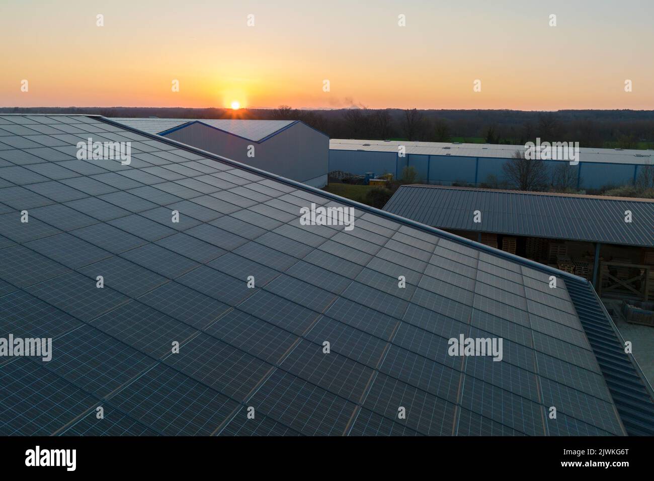 Blue photovoltaic solar panels mounted on building roof for producing ...