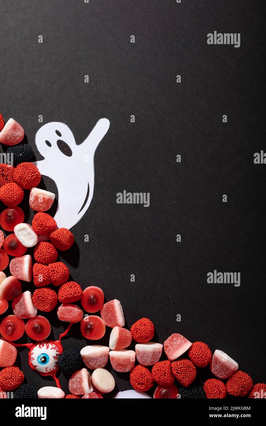 Halloween candies and ghost toy with copy space on grey background ...
