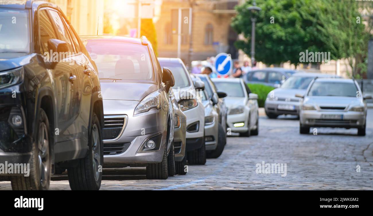 City traffic with cars parked in line on street side Stock Photo - Alamy