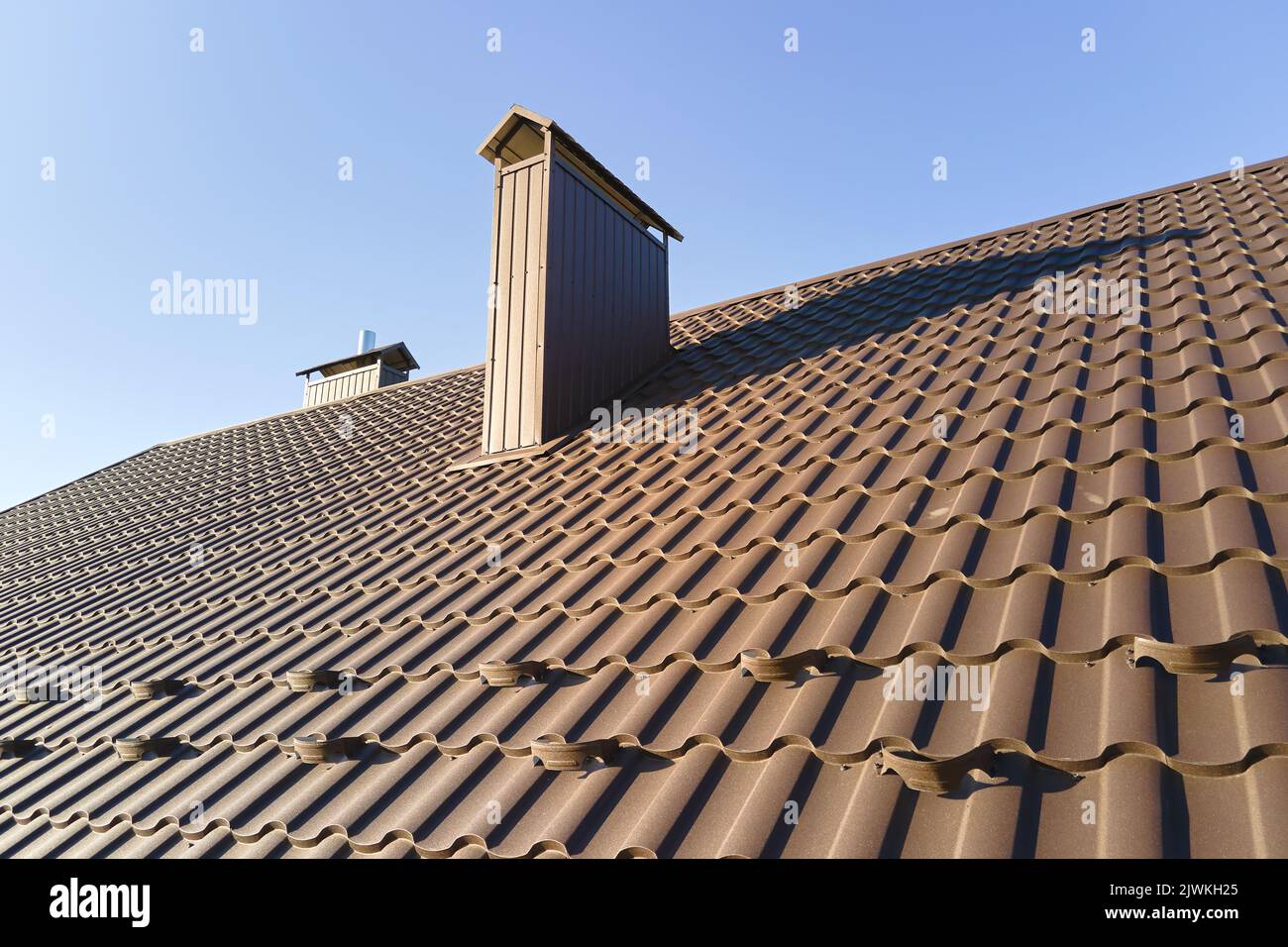 Closeup snow guard for safety in winter on house roof top covered with ...