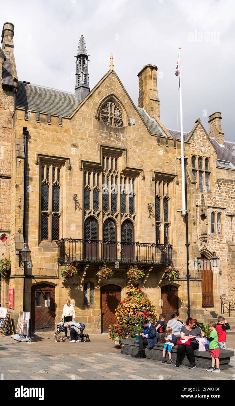 A family sitting outside Durham Guildhall in Durham market place ...