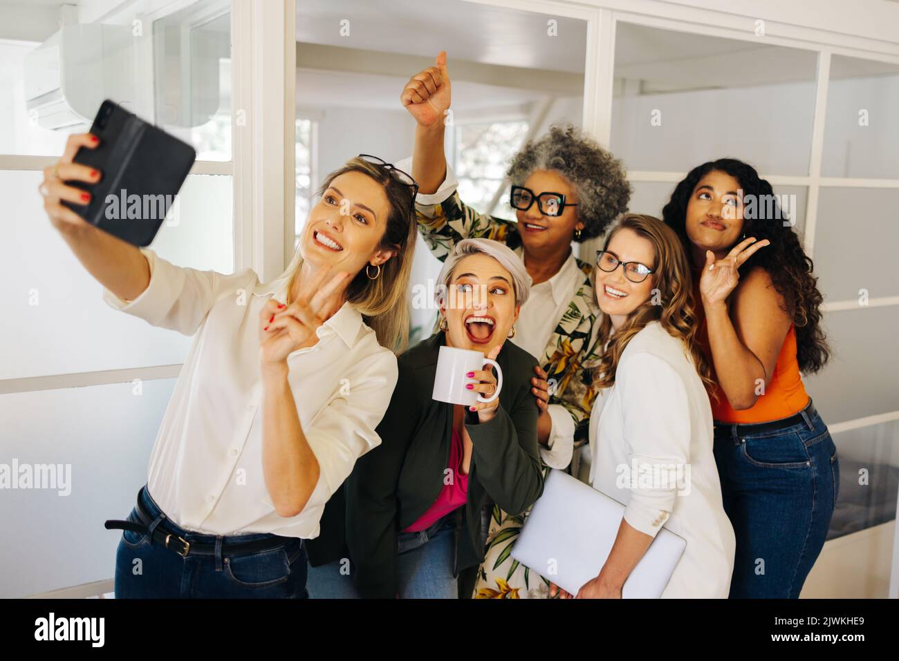 Multicultural businesspeople smiling happily while taking a selfie ... Multicultural businesspeople smiling happily while taking a selfie ...