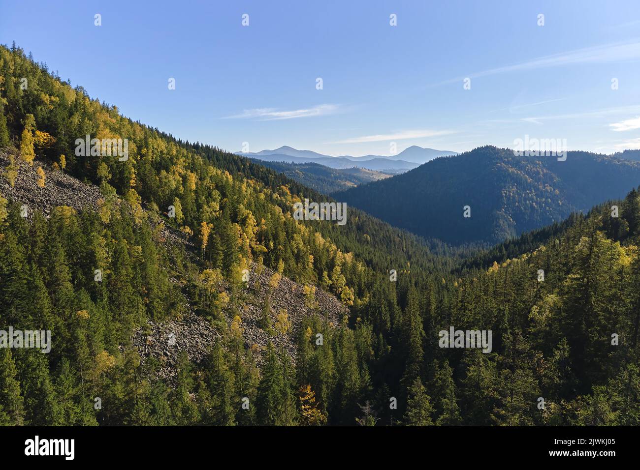 High hills with dark pine woods on autumn bright day. Amazing scenery ...