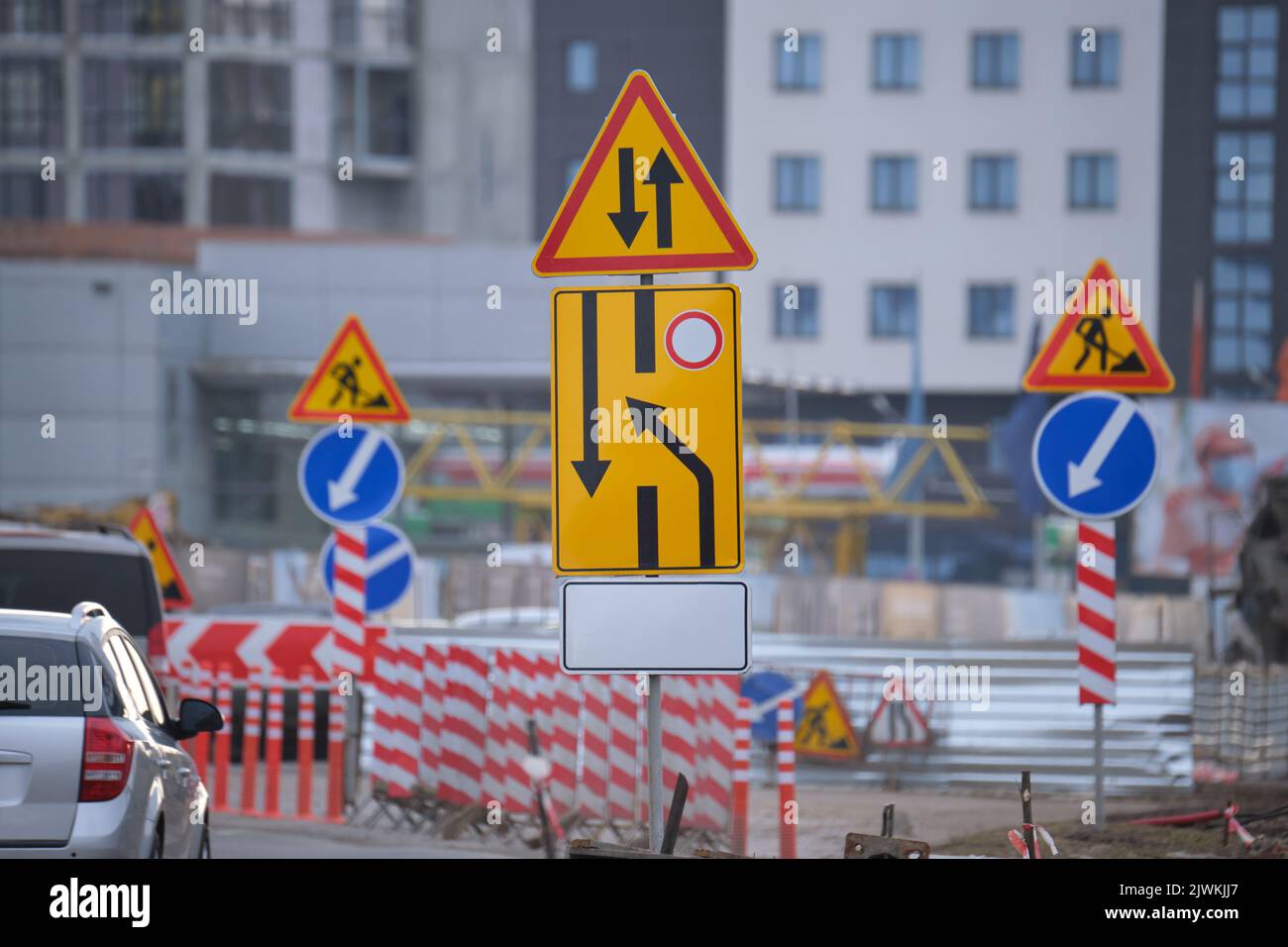 Roadworks warning traffic signs of construction work on city street and ...