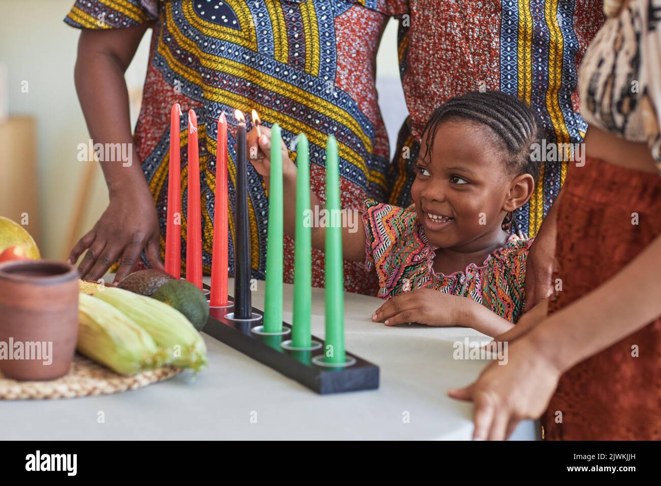 African little child burning candles for Kwanzaa holiday to celebrate ...