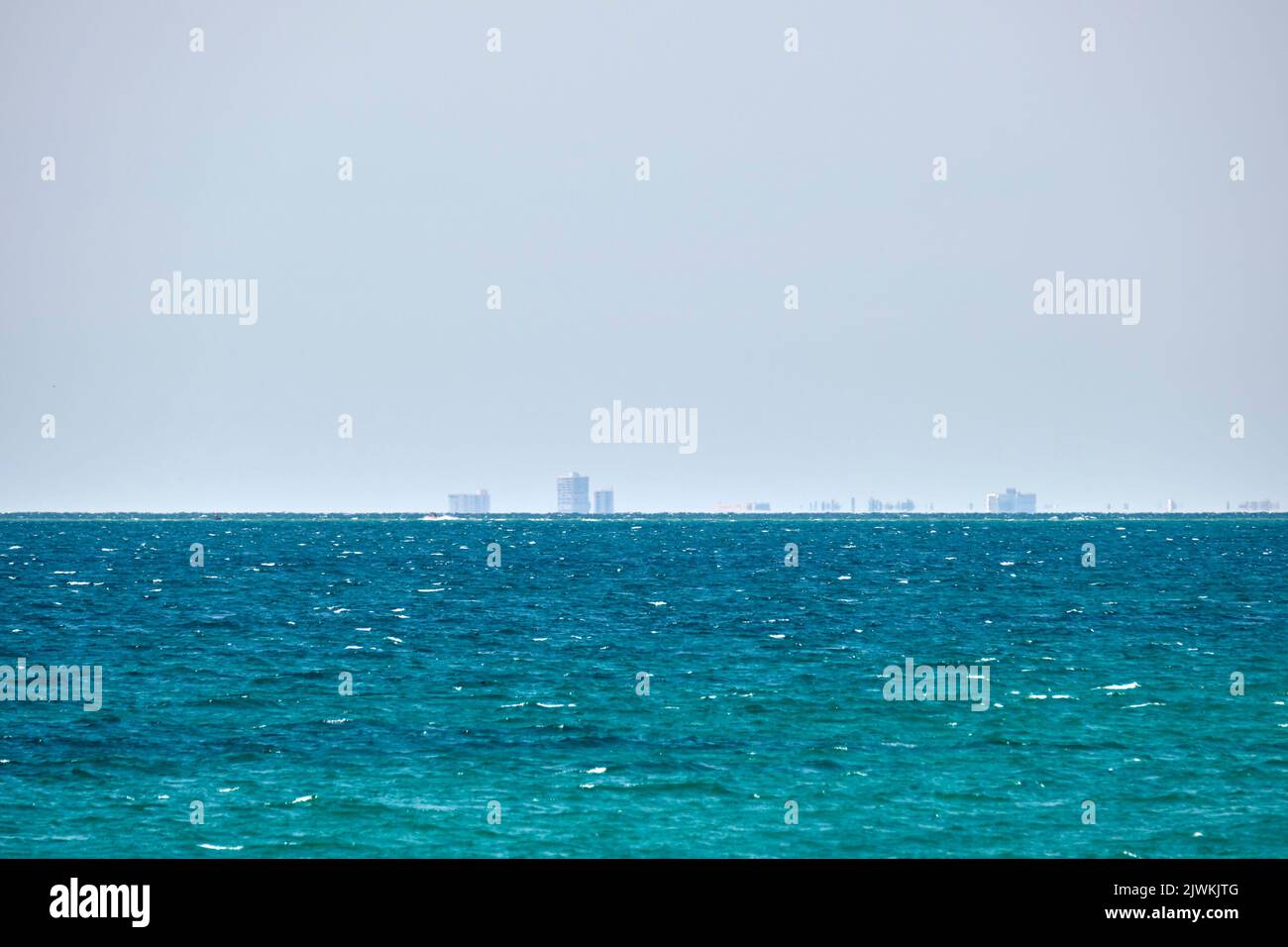 Sea panorama. Small motor boat floats in deap blue bay water under ...