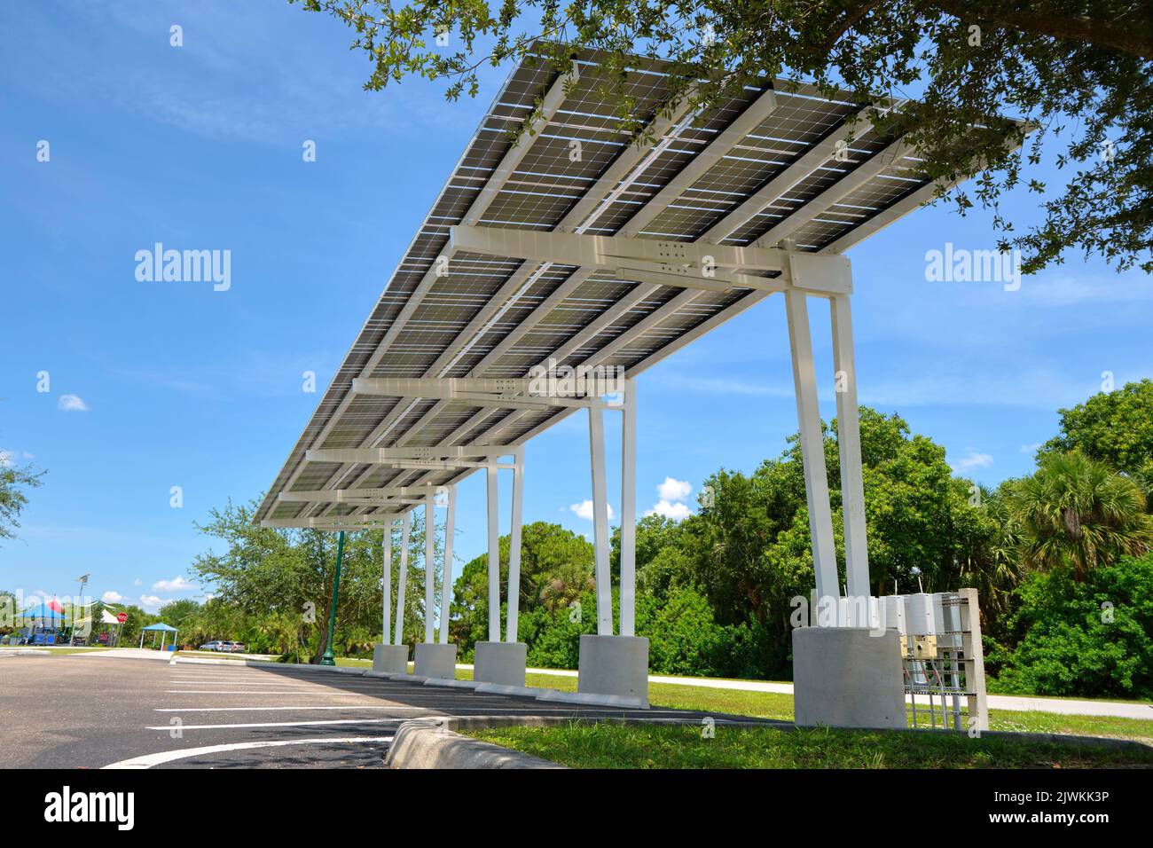 Solar panels installed over parking lot canopy shade for parked cars ...