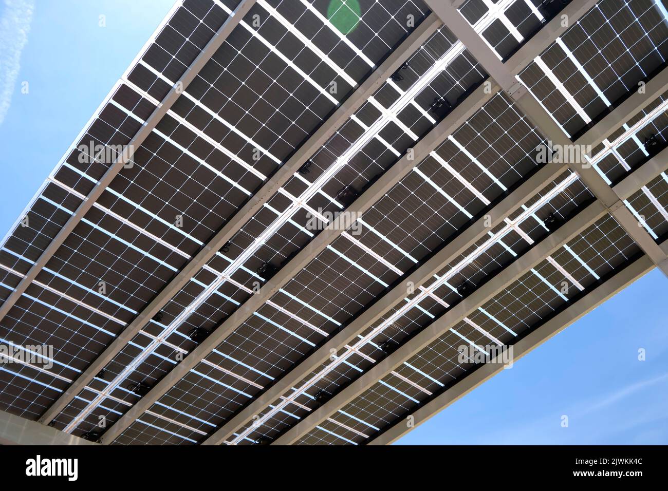 Solar panels installed over parking lot canopy shade for parked cars ...