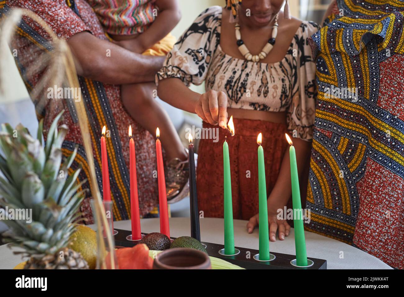 Close-up of African family of four in national costumes burning all ...
