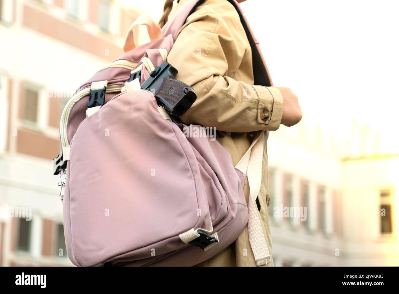 Firearms at school. Schoolgirl with a gun in a backpack on a school ...