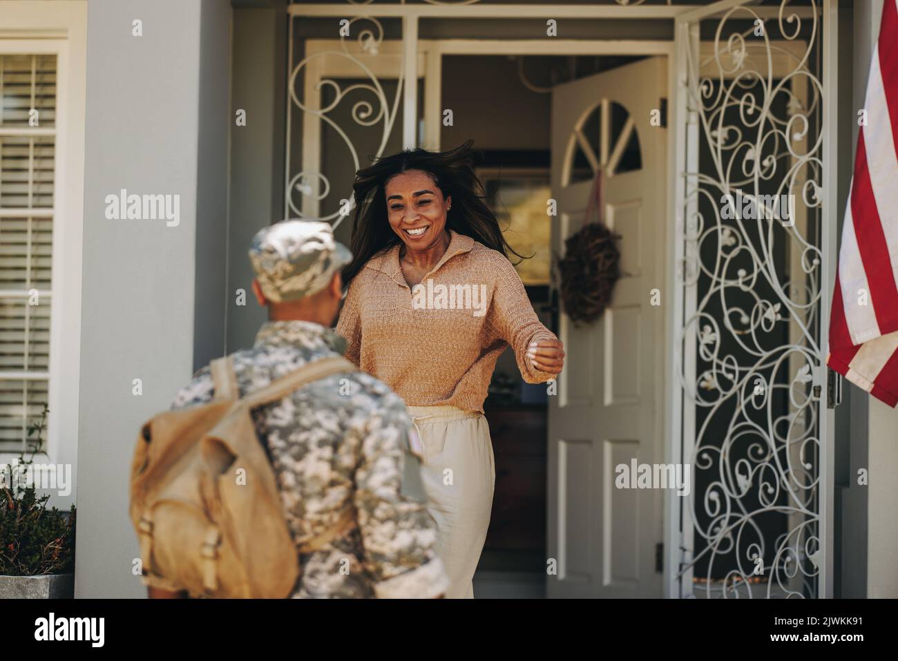Excited military wife welcoming her husband from the army. Happy ...