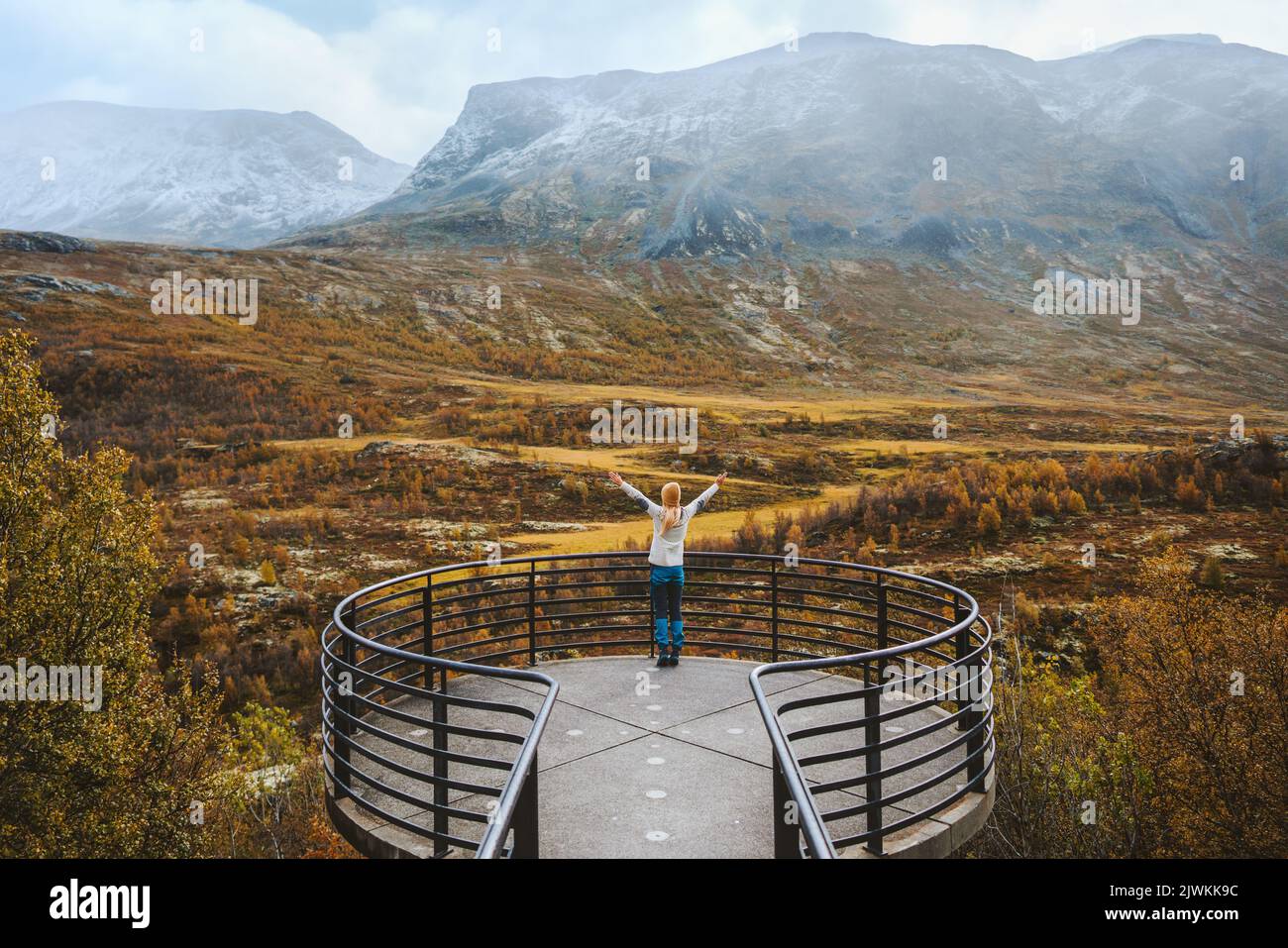 Woman enjoying autumn landscape on Vegaskjelet viewpoint travel outdoor ...