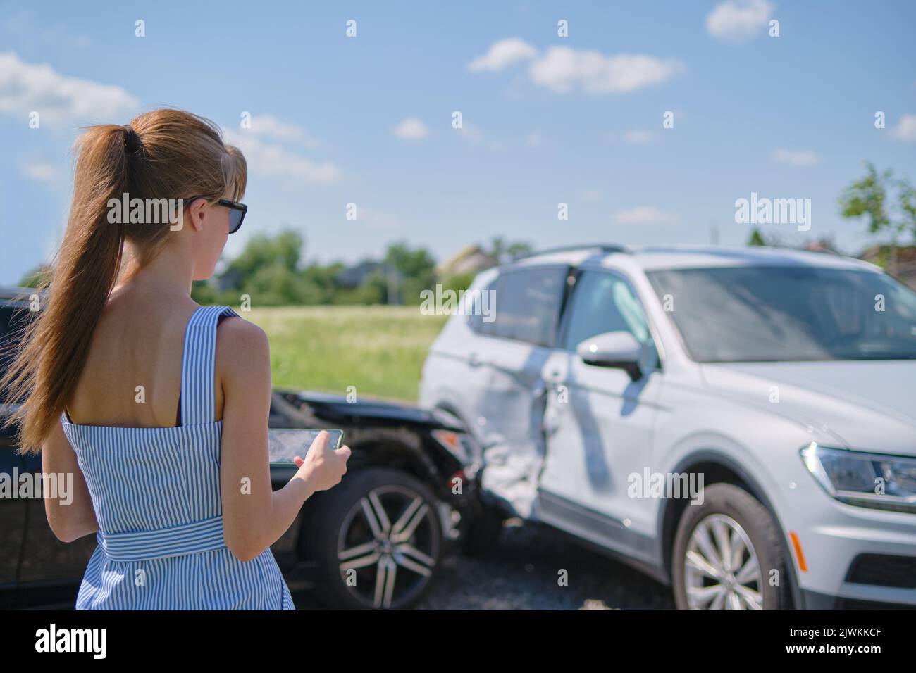 Stressed woman driver standing on street side shocked after car ...