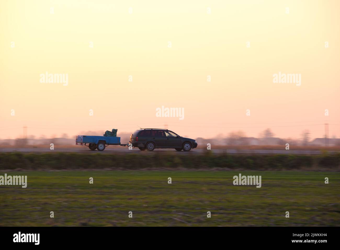 Tow truck vehicle with car carrier trailer driving on highway in ...