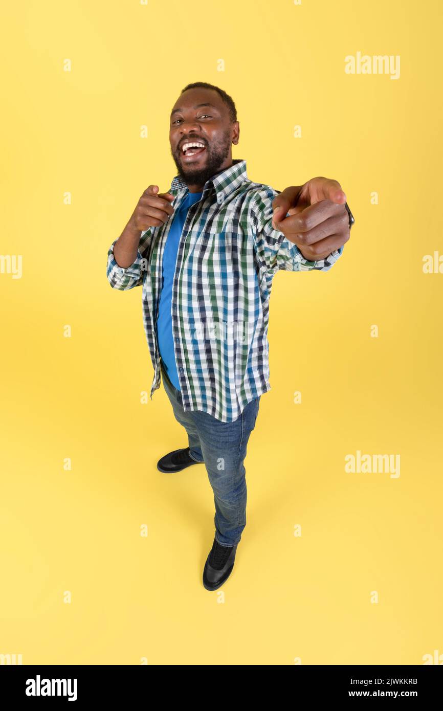 African American Guy Pointing Fingers At Camera Over Yellow Background ...