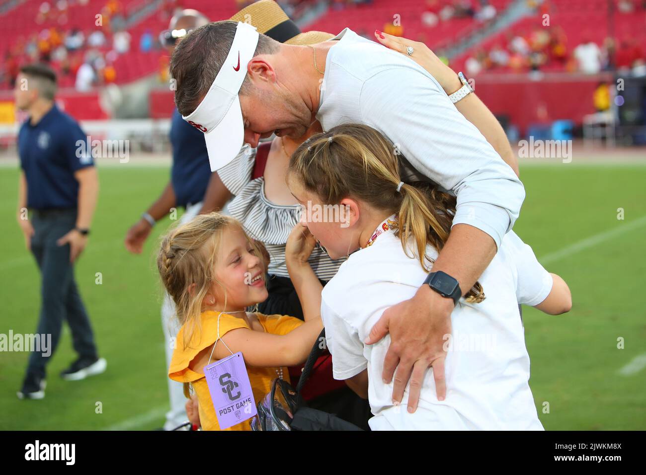 USC Trojans head coach Lincoln Riley hugs his daughters Stella (L) and ...