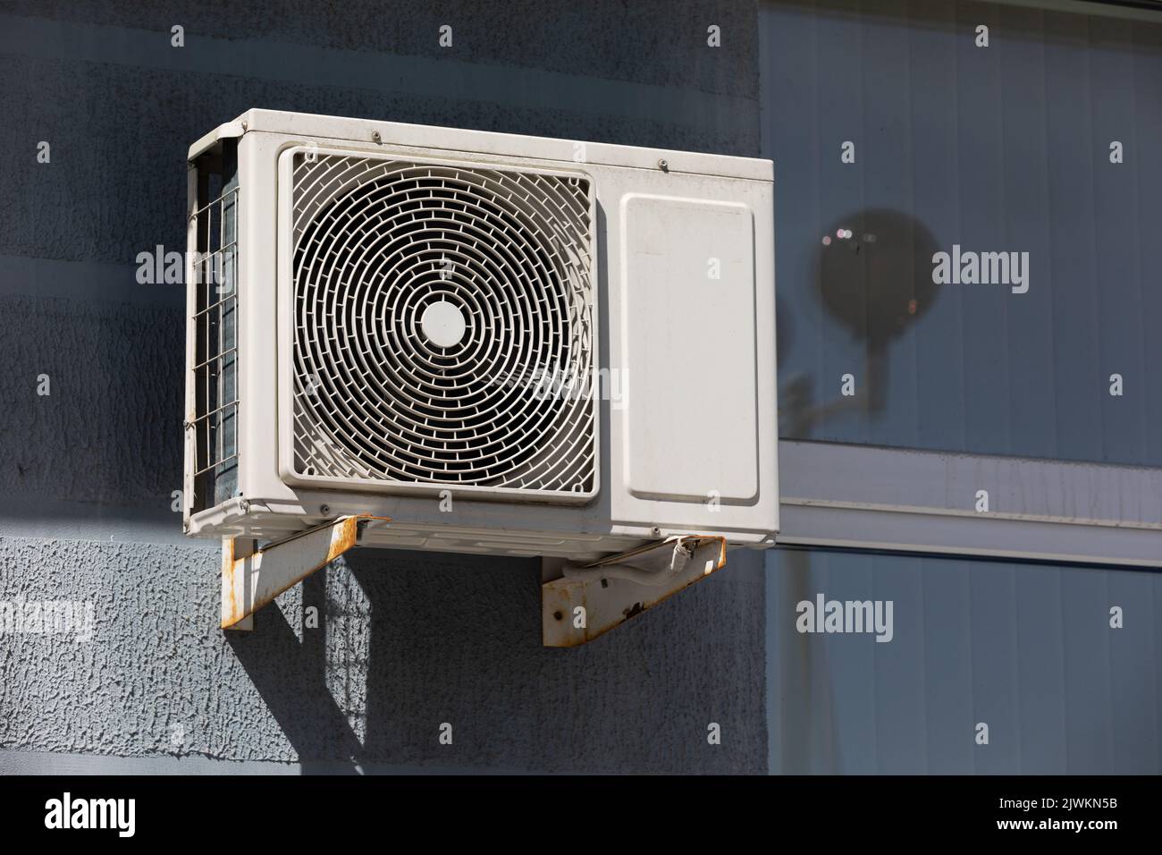 outdoor air conditioner unit on the wall of a building Stock Photo - Alamy