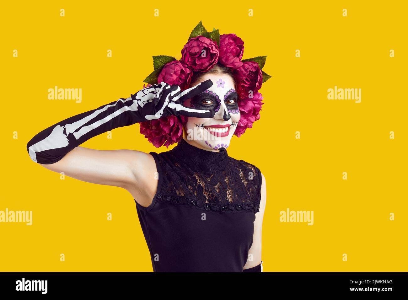 Happy woman dressed for Day of the Dead or Halloween smiling and doing ...