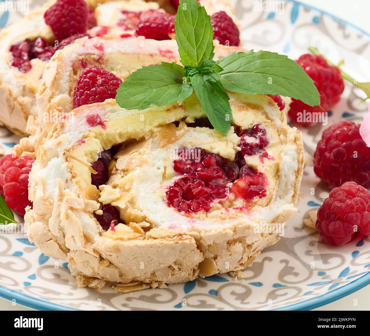 Baked meringue roll with cream and fresh red raspberry, white ...