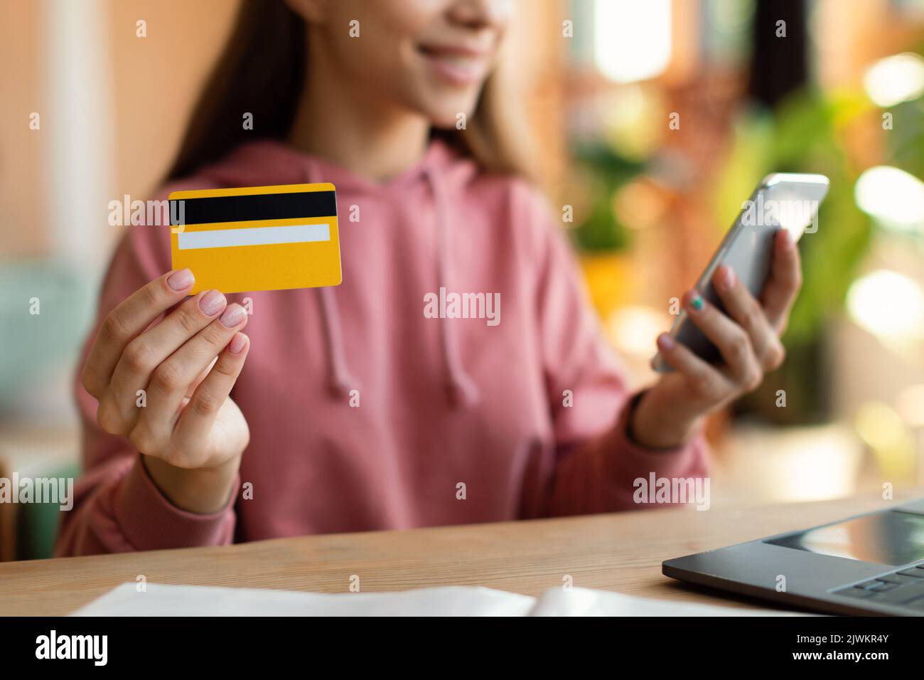 Smart teen girl student pay money with credit card and smartphone ...