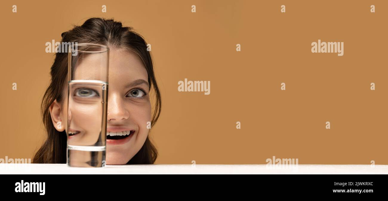 Creative art photography. Stylish girl's face through wine glass over ...