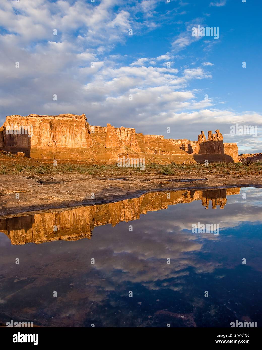The Three Gossips reflected in an ephemeral rainwater pool in the ...