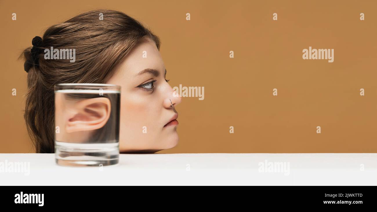 Creative art photography. Stylish girl's face through wine glass over ...