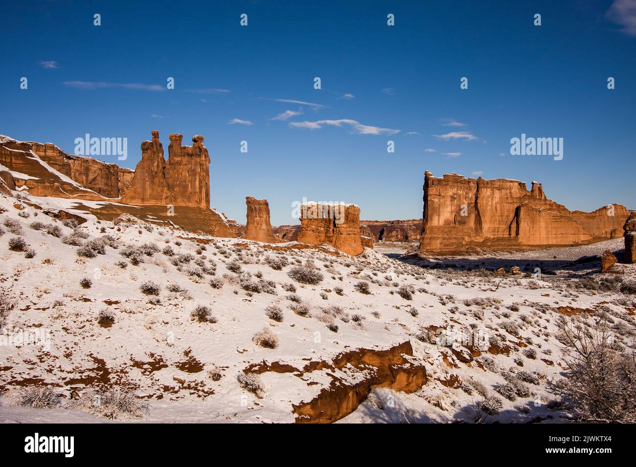 Three Gossips, Sheep Rock & Tower of Babel in the Courthouse Towers with snow in winter. Arches ...