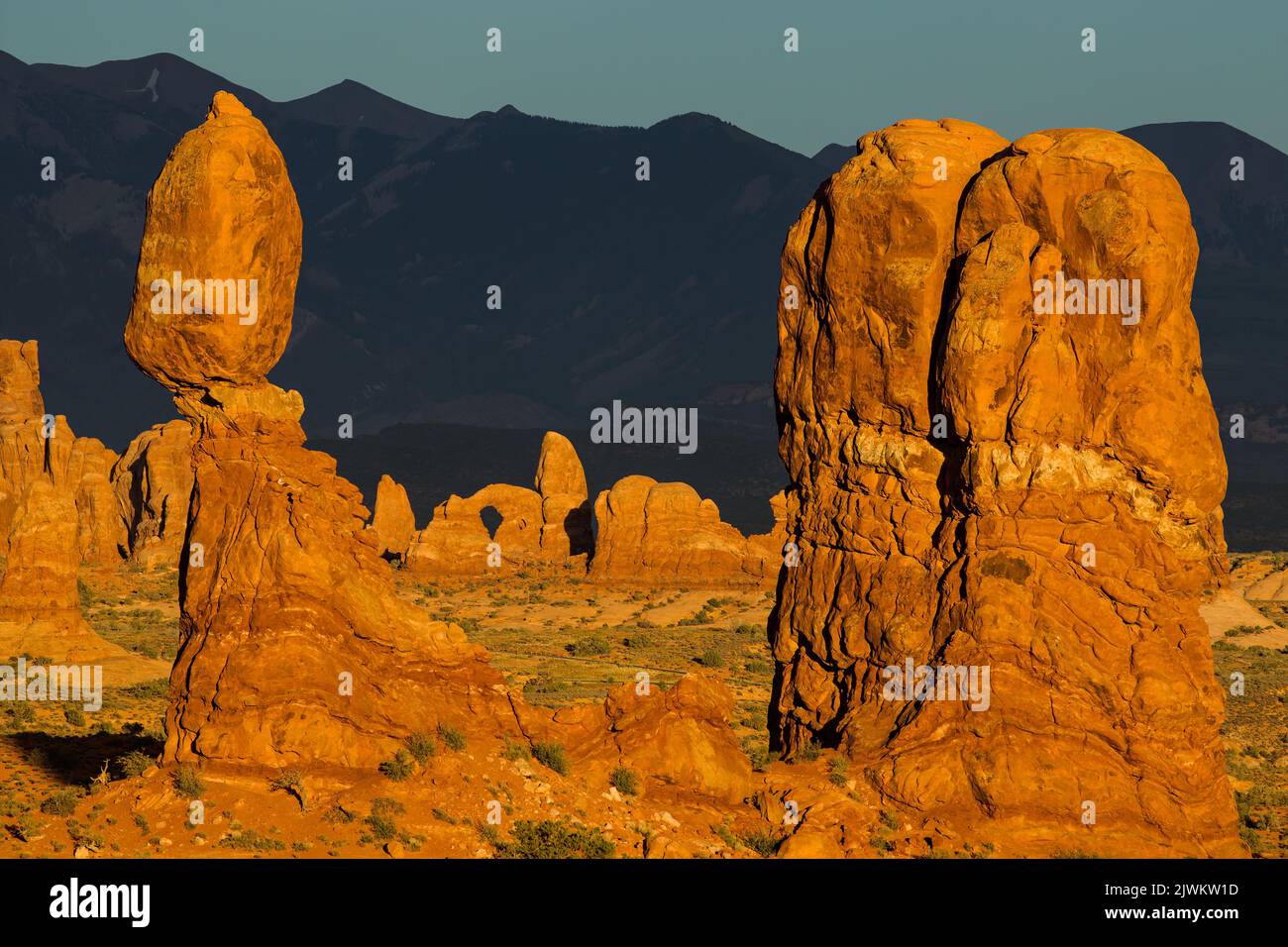 A telephoto view of Balanced Rock with Turret Arch and the La Sal ...