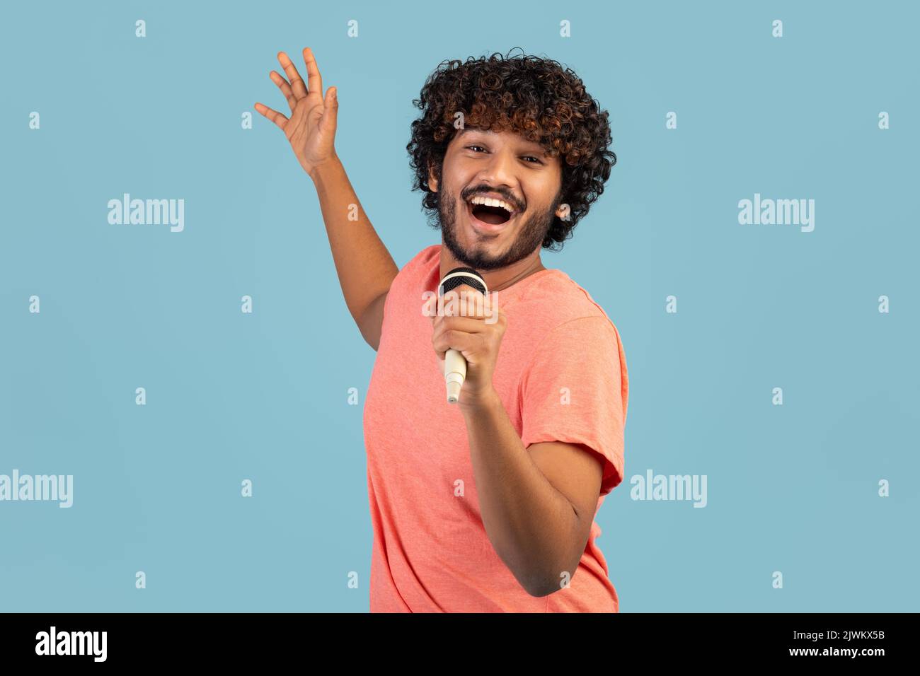 Indian man singing microphone smiling hi-res stock photography and ...