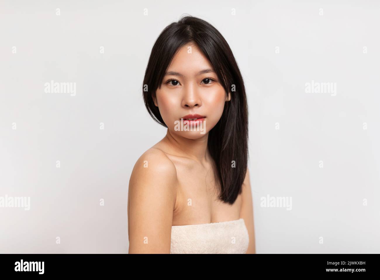 Pretty young korean lady with smooth skin and dark hair standing ...