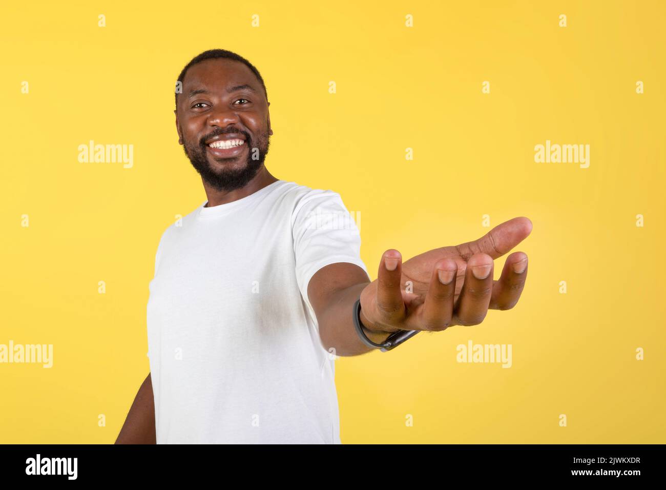 Happy Black Man Showing Invisible Object Standing Over Yellow ...
