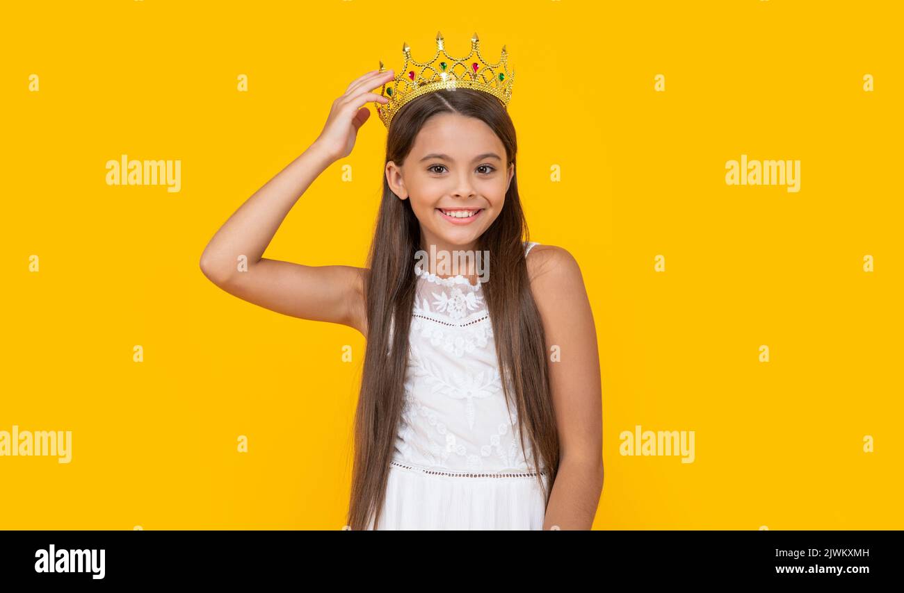 cheerful teen girl in crown on yellow background Stock Photo - Alamy