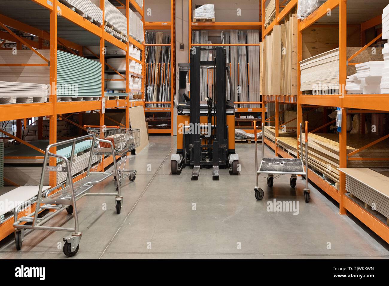 interior of a simple shop selling drywall and plywood with a forklift ...