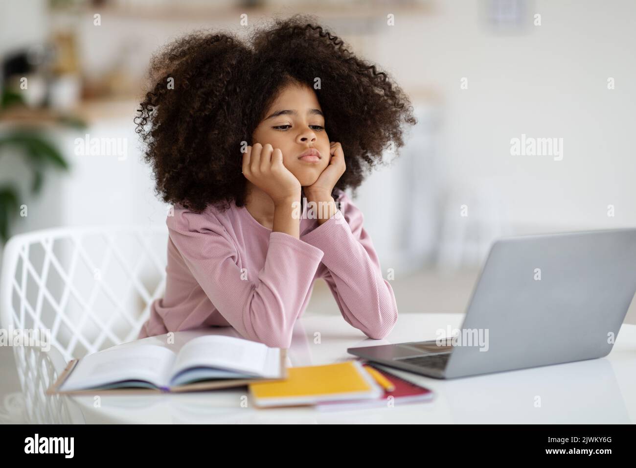 Exhausted school girl suffering while doing homework Stock Photo - Alamy