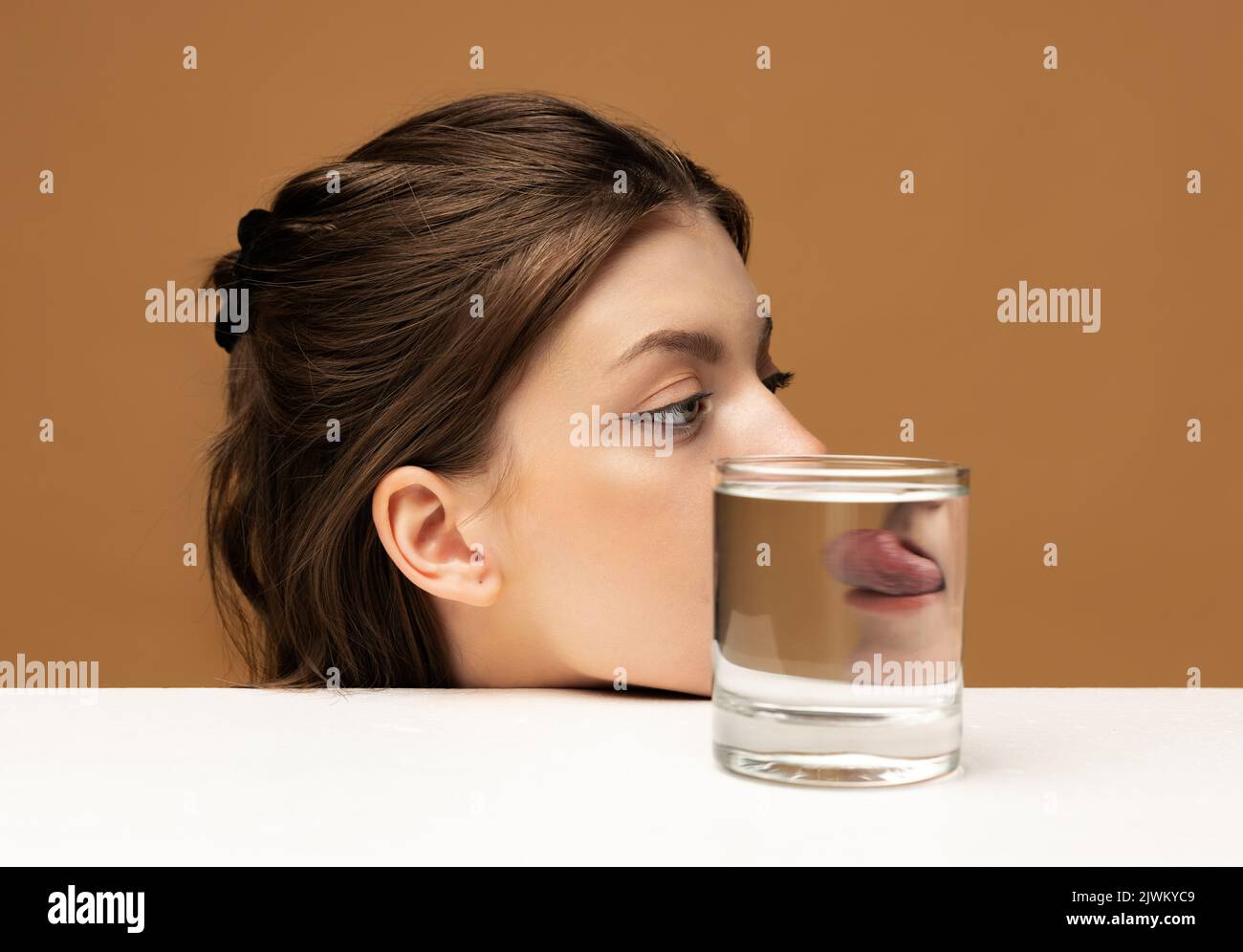 Taste. Modern art photography. Beautiful girl's face through glass of ...