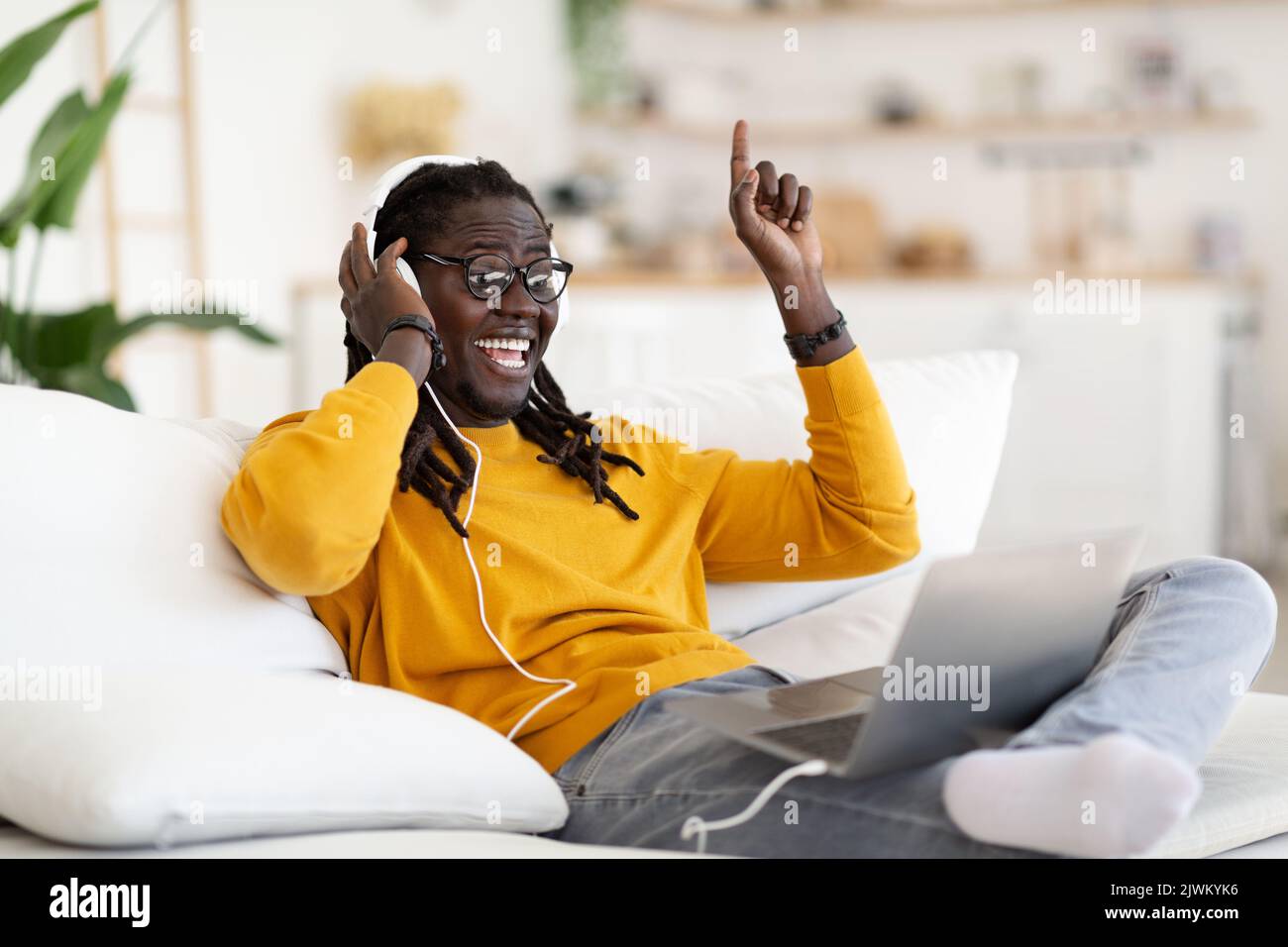 Black guy laptop dancing listening hi-res stock photography and images ...