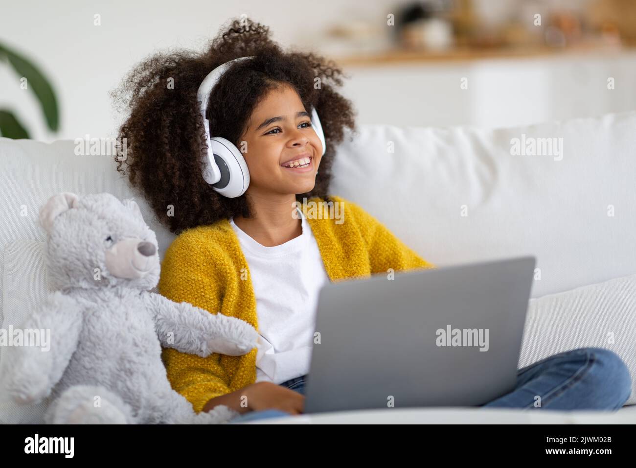 Cheerful black girl playing computer games at home Stock Photo - Alamy