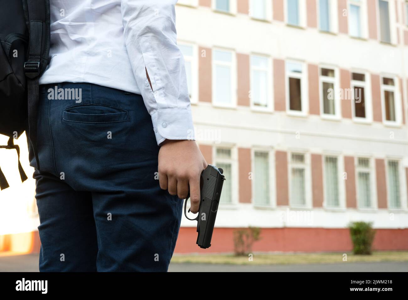 Firearms at school. A teenager with a gun on the background of the ...