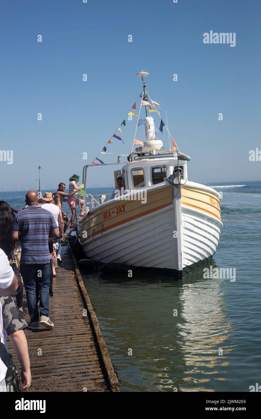 Tourists queue on the jetty to board the Sea Jay pleasure boat for ...