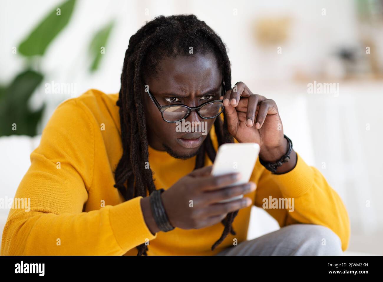 Eyesight Problems Concept. Young Black Man Wearing Eyeglasses Reading ...