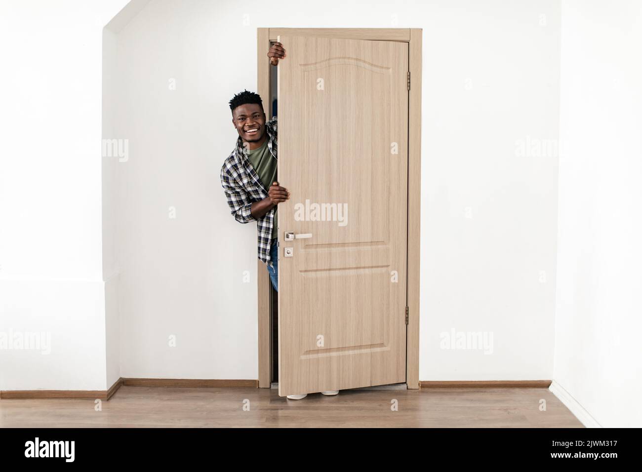 Man peeking door hi-res stock photography and images - Alamy