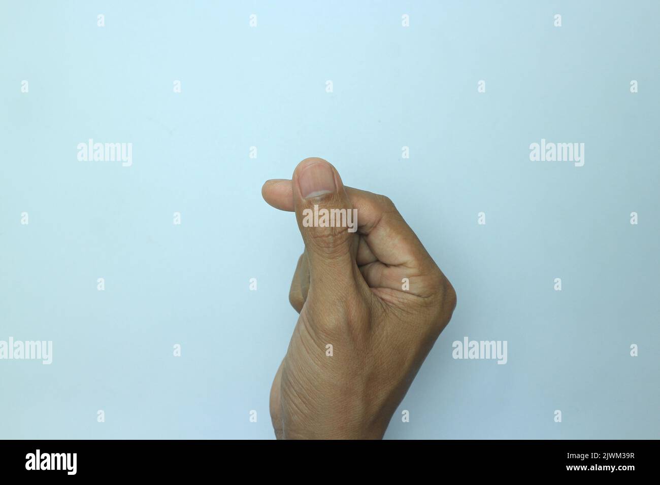A hand signs gesture to be little heart from tip of thumb and index ...