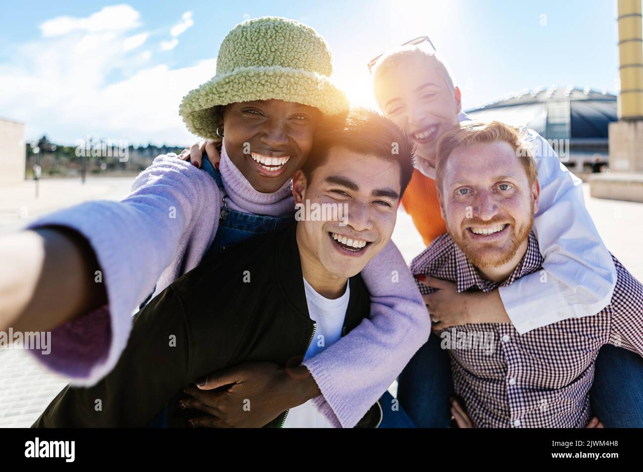 Self portrait of smiling group of young people taking selfie with phone ...