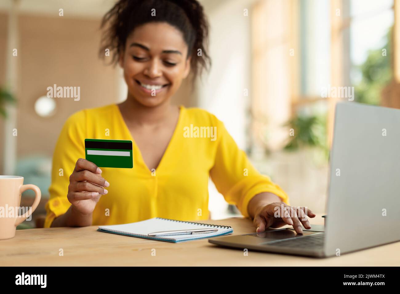 Easy payment and cashback concept. Smiling black lady doing online ...