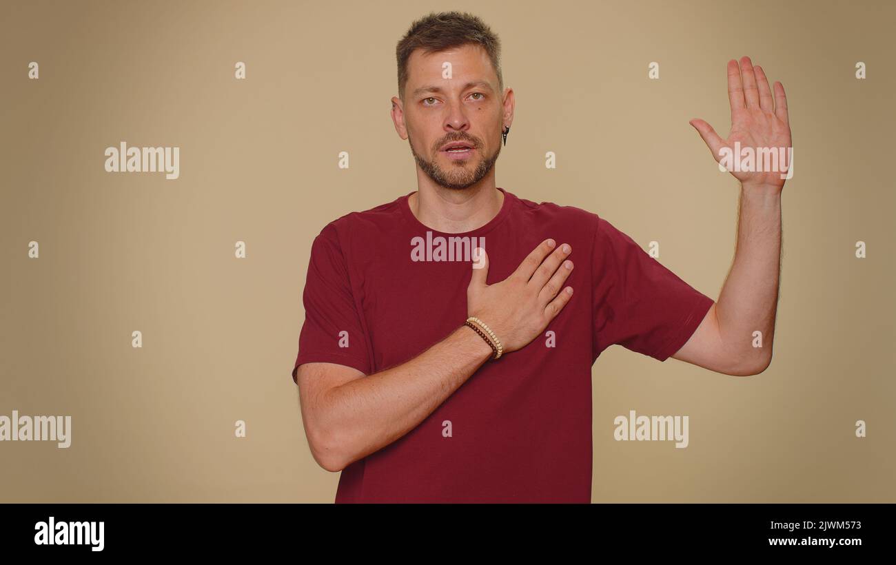 I swear to be honest. Sincere responsible handsome young man raising ...